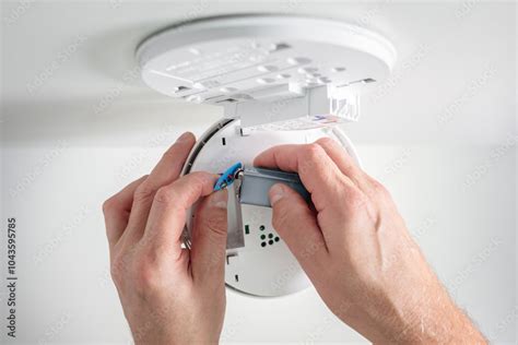 Inserting Battery In Home Smoke Detector And Fire Alarm Installing