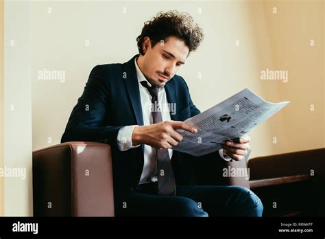 Adult Businessman In Suit Reading Newspaper In Hotel Room Stock Photo Alamy