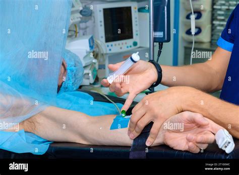 Intravenous Administration Of Anesthesia Through A Catheter To A Patient On The Operating Table