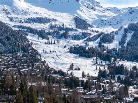 Aerial View Of Snow Covered Verbier Swiss Alps With Ski Trails And