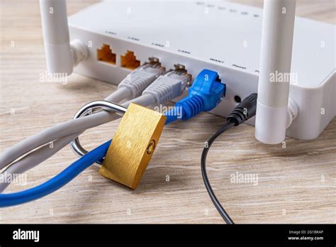 Locked Padlock On Network Cables Connected To Wi Fi Wireless Router On A Desk Prohibit And
