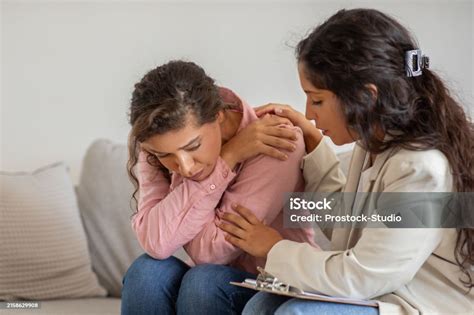 Woman Receives Comfort And Support From Therapist During Counseling