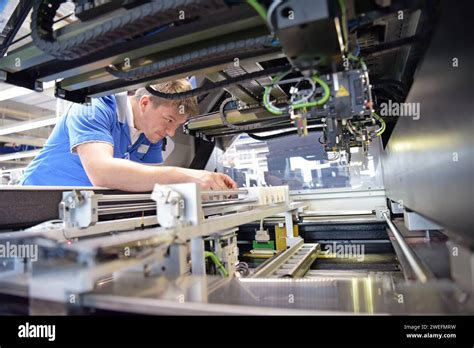 Engineer Working On A Machine For Assembly And Production Of