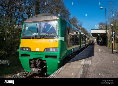 Class 321 Passenger Train In London Midland Livery Waiting At A Small Railway Station On The