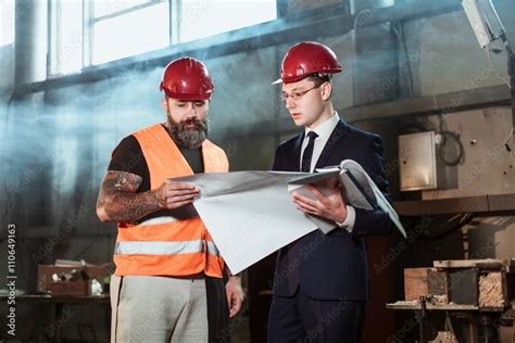 architect the suit and helmet and foreman builder in overalls and with