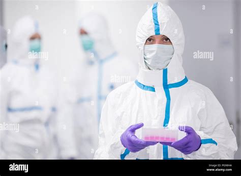 Lab Technician Carrying A Cell Based Testing Kit In A Laboratory That