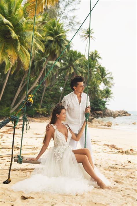 Happy Young Married Couple Celebrating Their Wedding On The Beach Stock