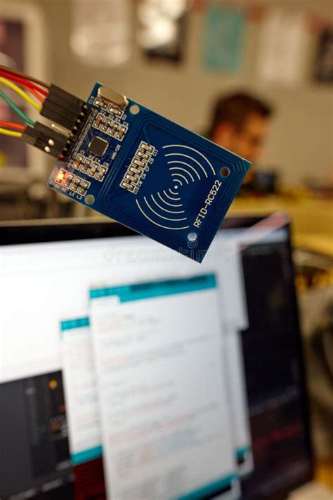 Selective Focus Of A Module Board Against A Blurry Computer Screen Under Maintenance Setup