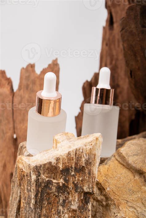 Pair Of Frosted Glass Dropper Bottles With Rose Gold Caps On Rustic