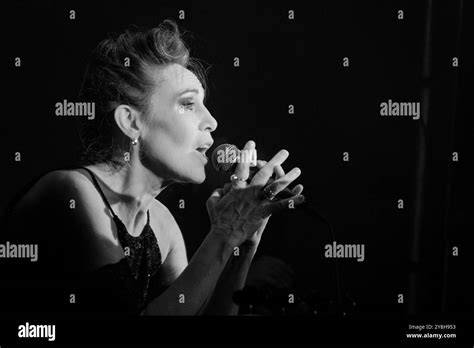 A Close Up Black And White Picture Of Mona Soyoc Lead Singer Of Kas Product Reloaded In Concert