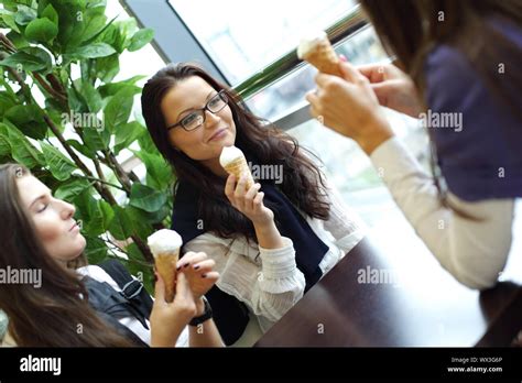 Women On Foreground Licking Ice Cream Stock Photo Alamy
