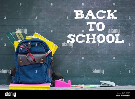 School Backpack And School Supplies With Chalkboard Background