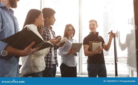 Students Writing Assignments On Whiteboard In Classroom Stock Image