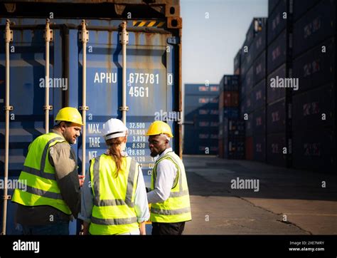 Group Of Workers In An Empty Container Storage Yard The Condition Of The Old Container Is Being