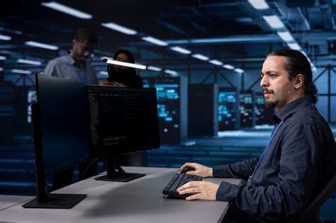 Premium Photo Programmer Typing On Pc In Data Center Updating Systems