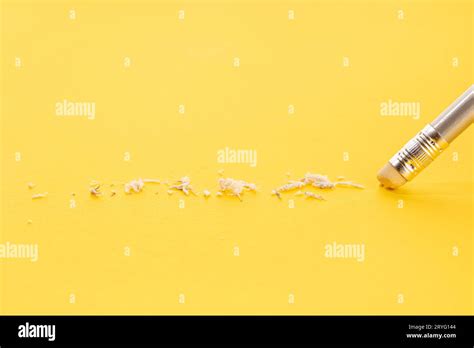 Pencil Eraser Working On Yellow Paper Background Mistake Erasing Or