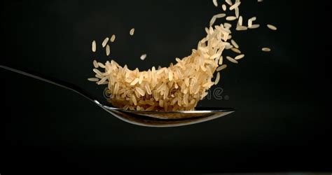 Rice Falling In A Spoon Against Black Background Stock Image Image Of