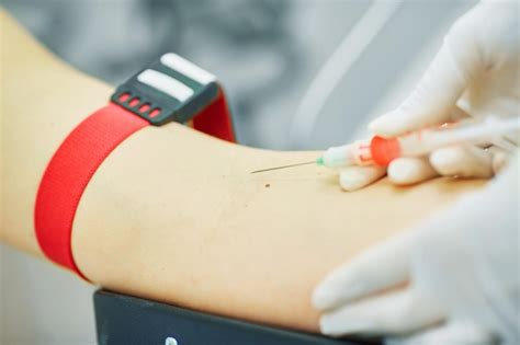 Premium Photo The Doctor Makes An Injection In The Vein And Arm Of