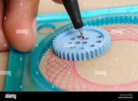 Drawing The Spirograph Pattern With Spirograph Kit Stock Photo Alamy