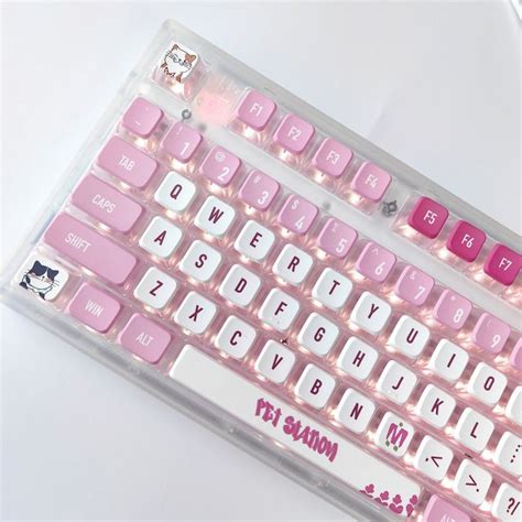 A Pink And White Keyboard Sitting On Top Of A Table