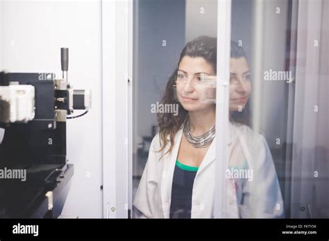 Female Scientist Monitoring Motor Alignment On X Ray Diffractometer