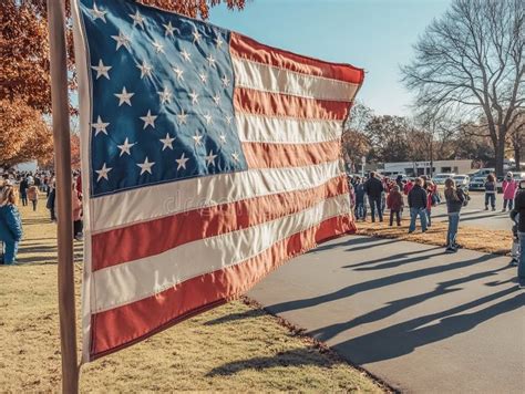American Flag Waving In The Breeze At A Public Gathering With People