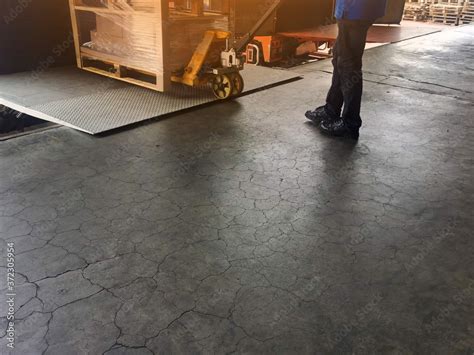 Worker Driving Forklift Loading Shipment Carton Boxes And Goods On Wooden Pallet At Loading Dock