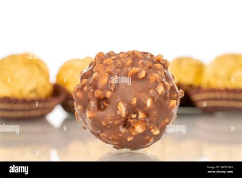 Several Chocolate Candies With Nuts In A Paper Wrapper Macro Isolated