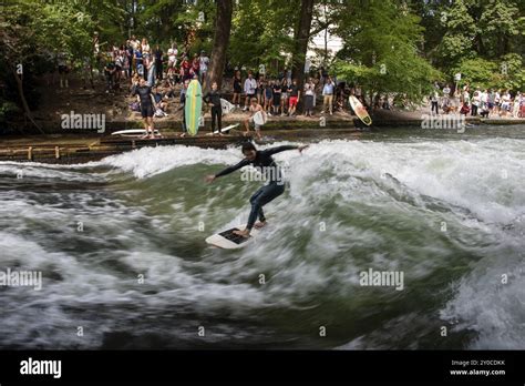 Surfers In The Eisbach Numerous Onlookers On The Banks Eisbach Wave In The English Garden Is