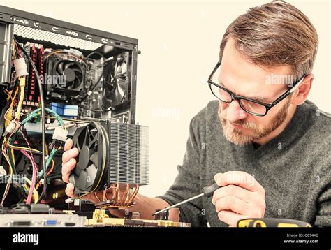 computer technician installs cooling system of computer toned image