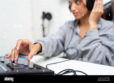 Female Audio Engineer Fine Tuning The Sound On Knob In Recording Studio Stock Photo Alamy