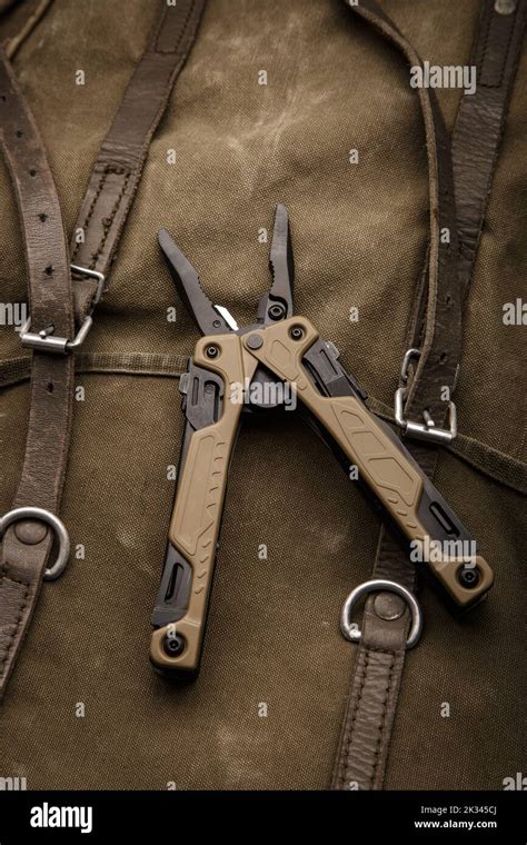 Modern Multitool With Many Tools A Portable Multitasking Tool On A Vintage Canvas Backpack