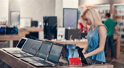 Premium Photo A Young Girl Is Testing A Laptop In An Electronics