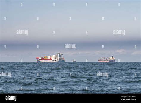 Container Feeder Ship And Bulk Carriers At Anchor In Jade Weser Estuary