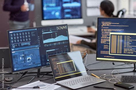 background image of multiple computer screens with data and code on