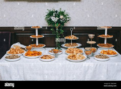 Catering Table With Salty Snacks Variety Of Chips Nuts And Snacks
