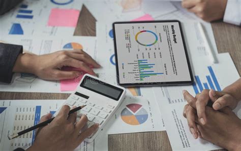 Business Bookkeeper Working With A Calculator To Calculate Business Data Summary Report