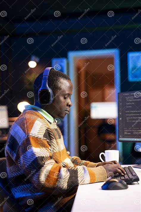 male programmer working on developing new html script stock image
