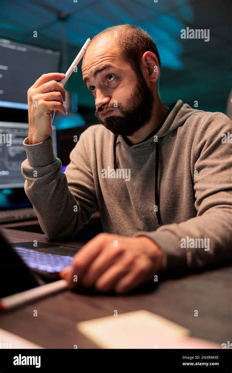 Thoughtful Developer Brainstorming Ideas To Find Source Code And Develop Html Script On Terminal