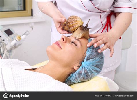 Getting Snail Skin Cleaning At Beauty Salon Stock Photo By Nikolasvn