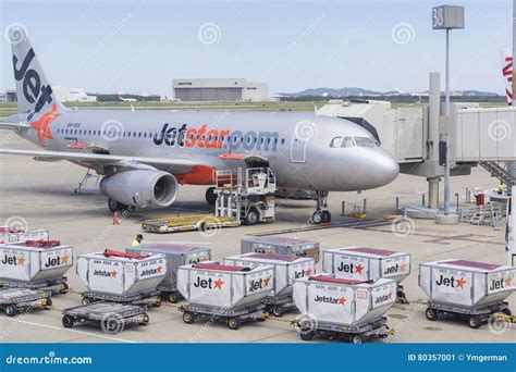 Baggage Trucks And Jetstar Aircraft At Brisbane Airport Editorial Photo