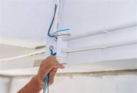 Premium Photo Close Up Electrician Hand Pulling Wire Into Pvc Conduit Install New Electric System