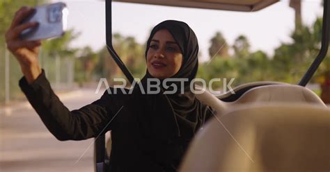 A Saudi Gulf Arab Woman Having Fun In One Of The Tourist Resorts Riding The Tourist Trolley