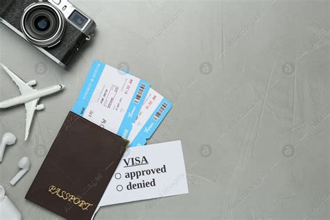 Flat Lay Composition With Passport Toy Plane And Camera On Grey