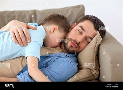 Happy Father And Son Sleeping On Sofa At Home Stock Photo Alamy