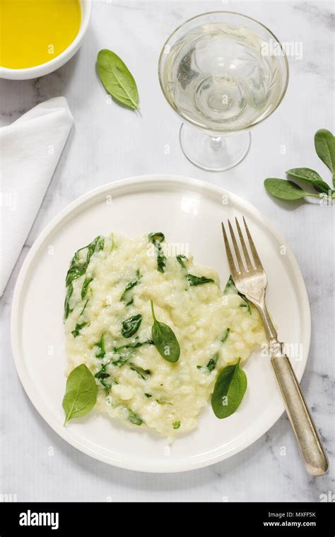 Gentle Cream Risotto With Spinach Served With Wine Light Background