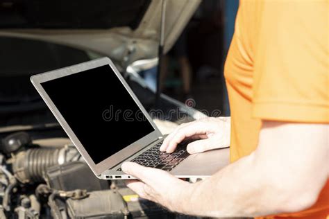 A Car Mechanic is Using a Laptop Computer To Check the Engine Operation Stock Photo - Image of ...