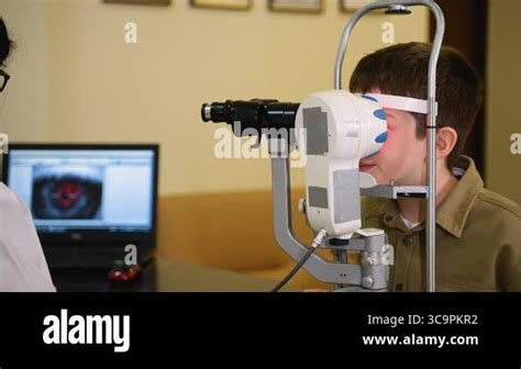 Skilled Ophthalmologist Performing Comprehensive Pediatric Eye Examination Using Advanced Non