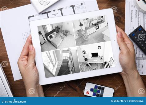 Woman Monitoring Cctv Cameras On Tablet At Wooden Table Top View Home