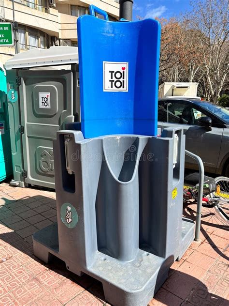 Portable Toilet Unit With Blue Privacy Screen In Urban Setting For